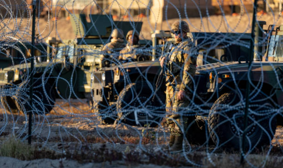 Texas Guards Defend Border: Migrants Hurdle Razor Wire in Tense ...